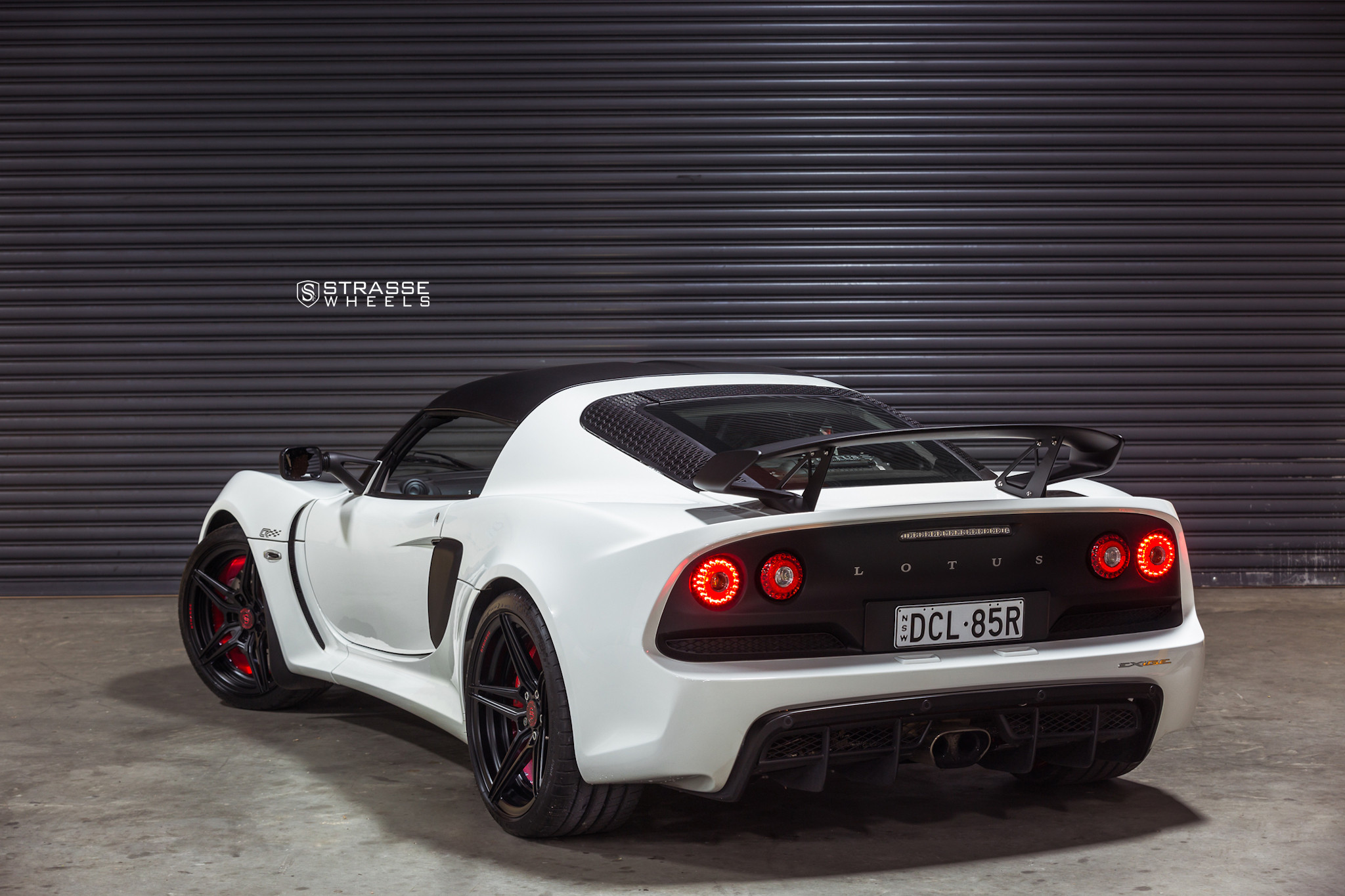 Modified White Lotus Exige Wearing Aftermarket Body Kit and Strasse ...